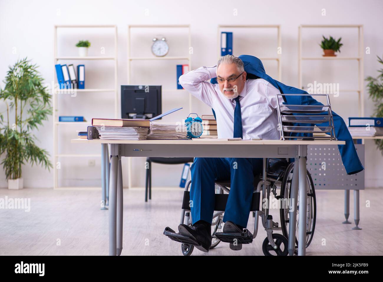 Old businessman in wheel-chair in time management concept Stock Photo ...