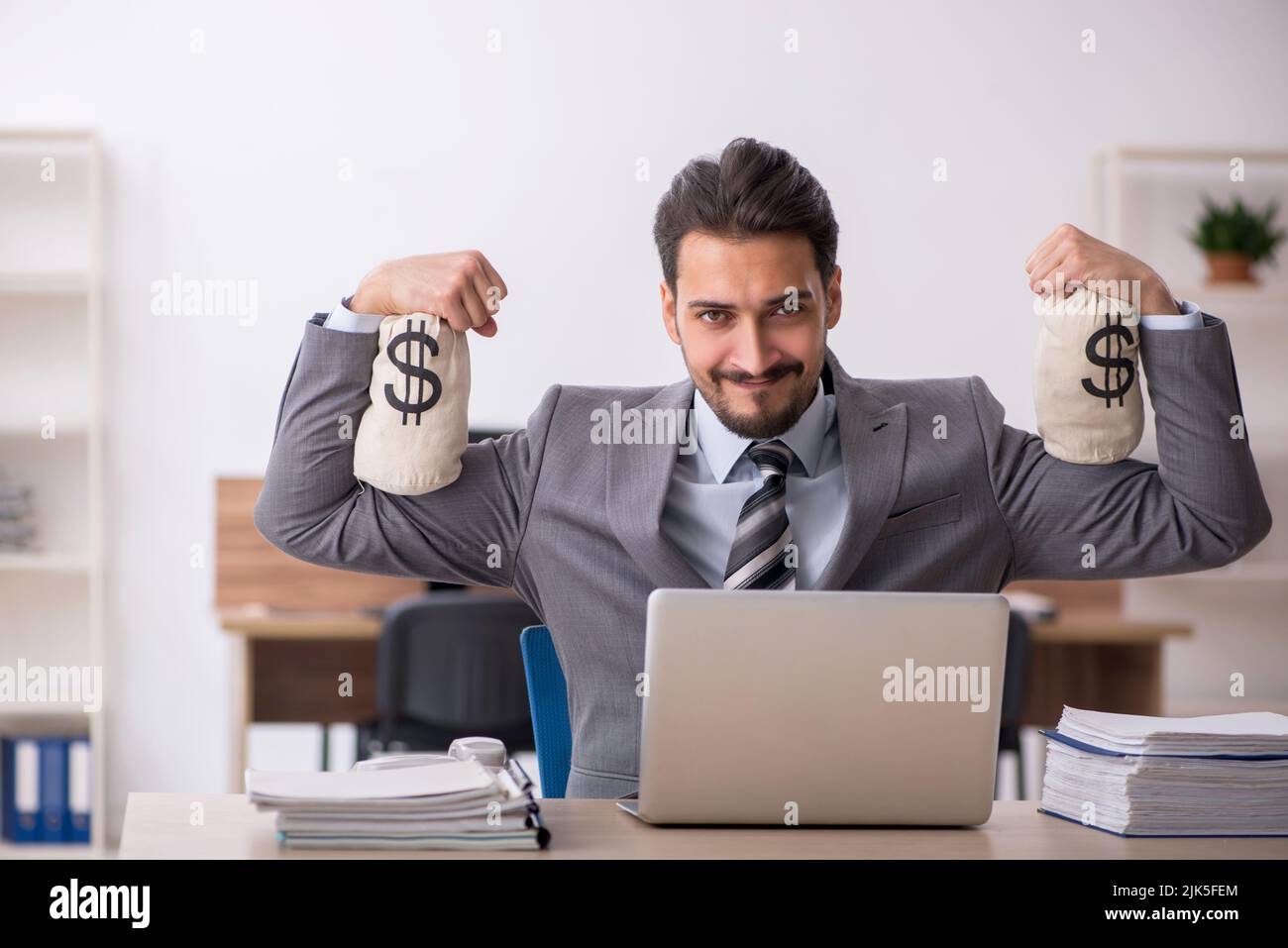Young businessman employee in remuneration concept Stock Photo - Alamy