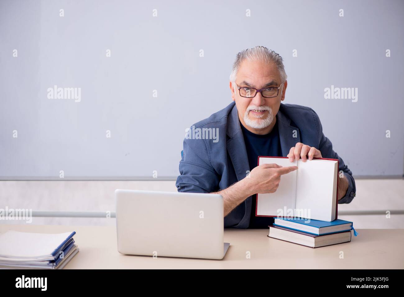 Old teacher in the classroom Stock Photo - Alamy