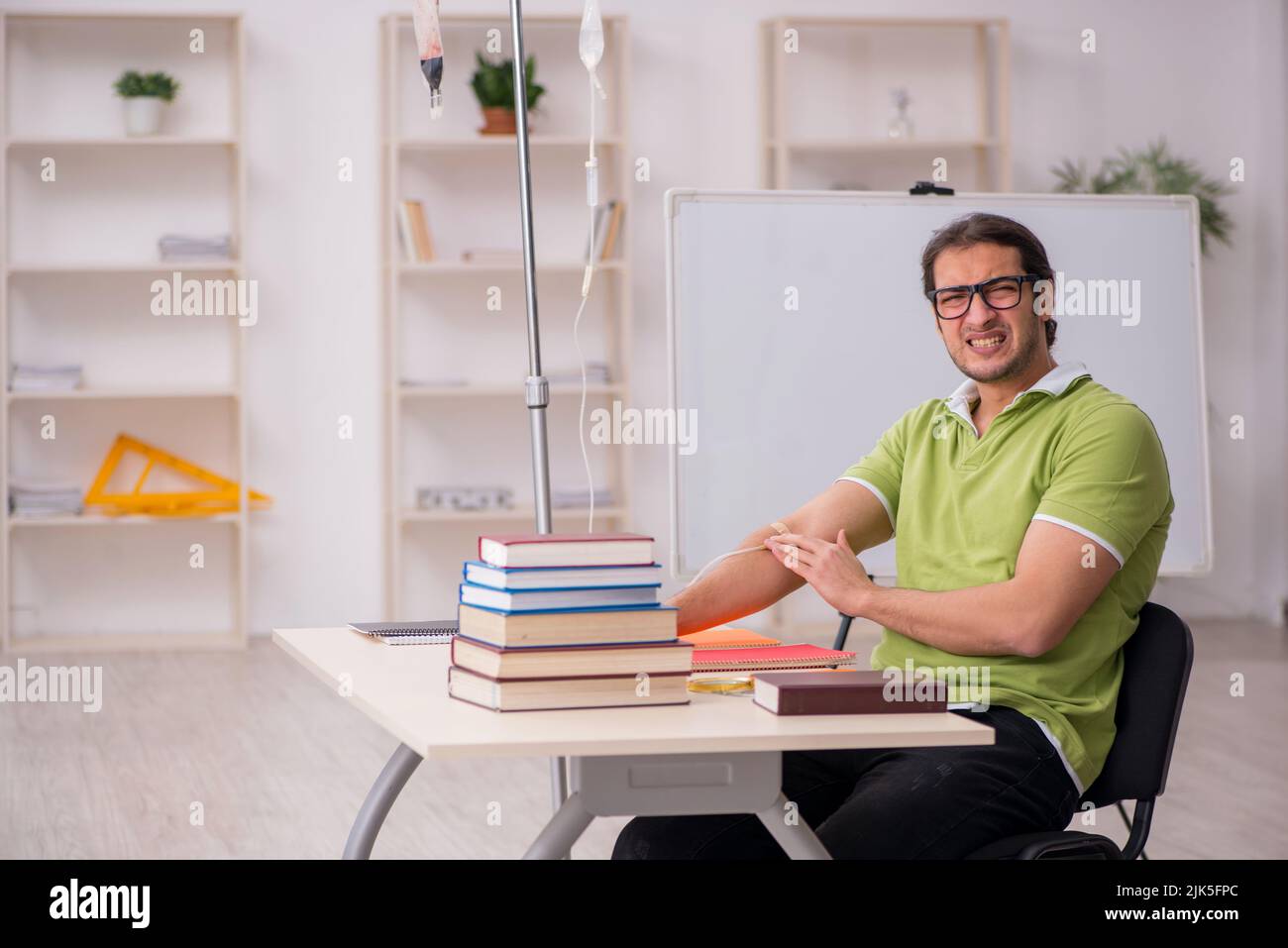 Young sick teacher student in blood transfusion concept Stock Photo - Alamy