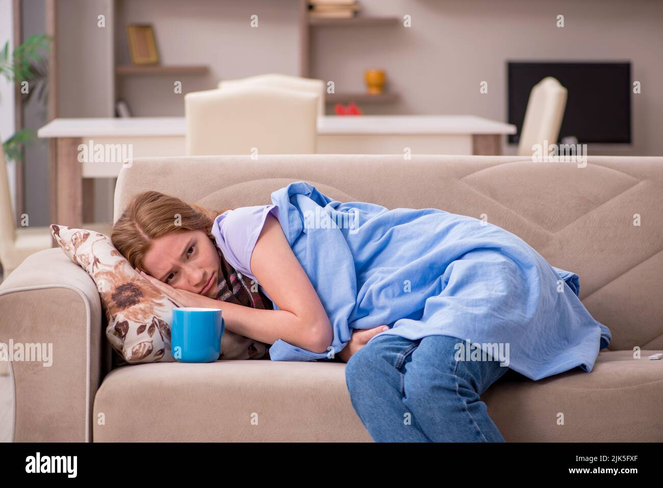 Young woman feeling bad at home Stock Photo - Alamy