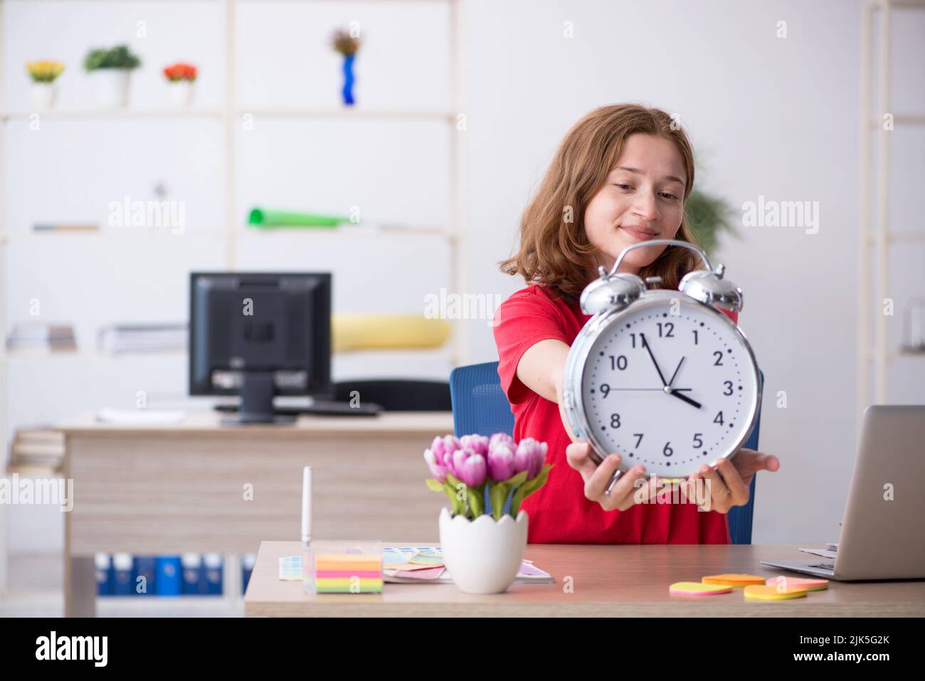 Female designer in time management concept Stock Photo - Alamy