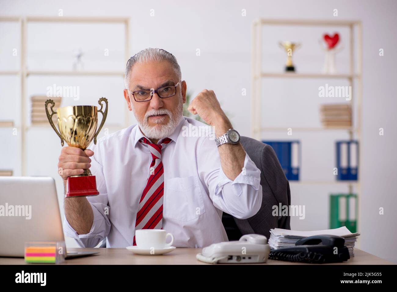Golden trophy is being awarded to the winner hi-res stock photography ...