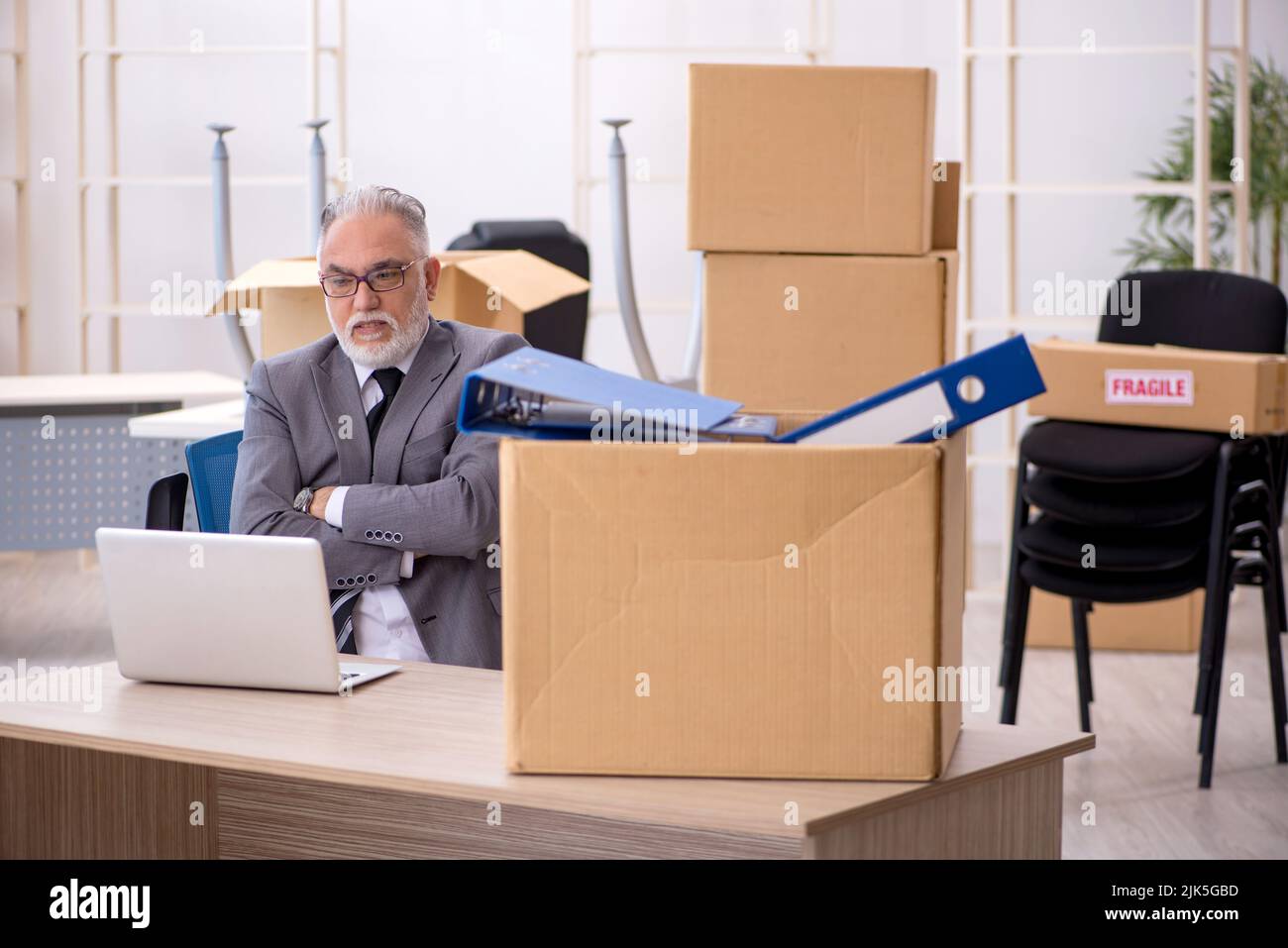 Old employee in relocation concept Stock Photo - Alamy