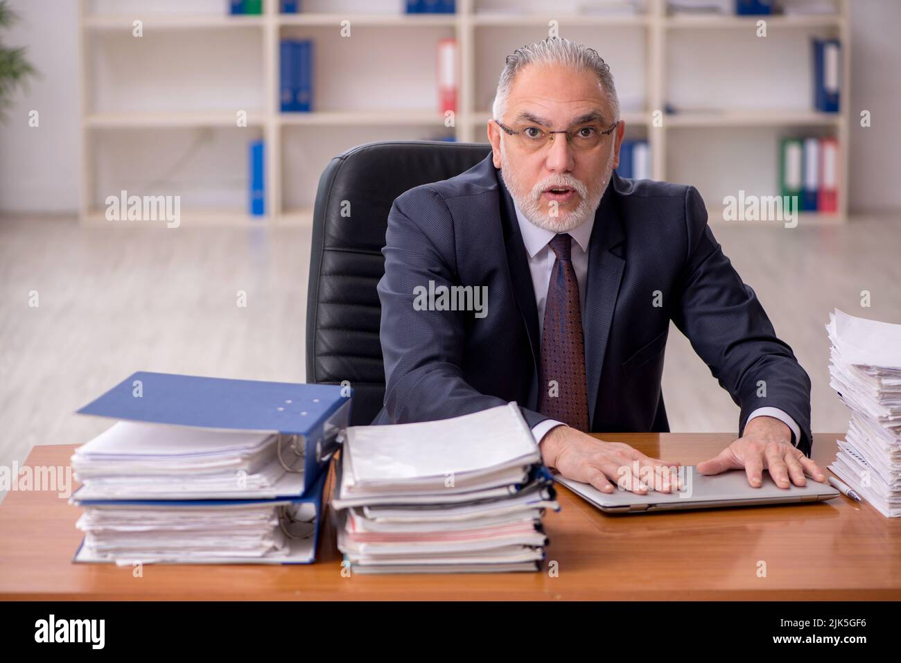 Old male employer and too much work at workplace Stock Photo - Alamy