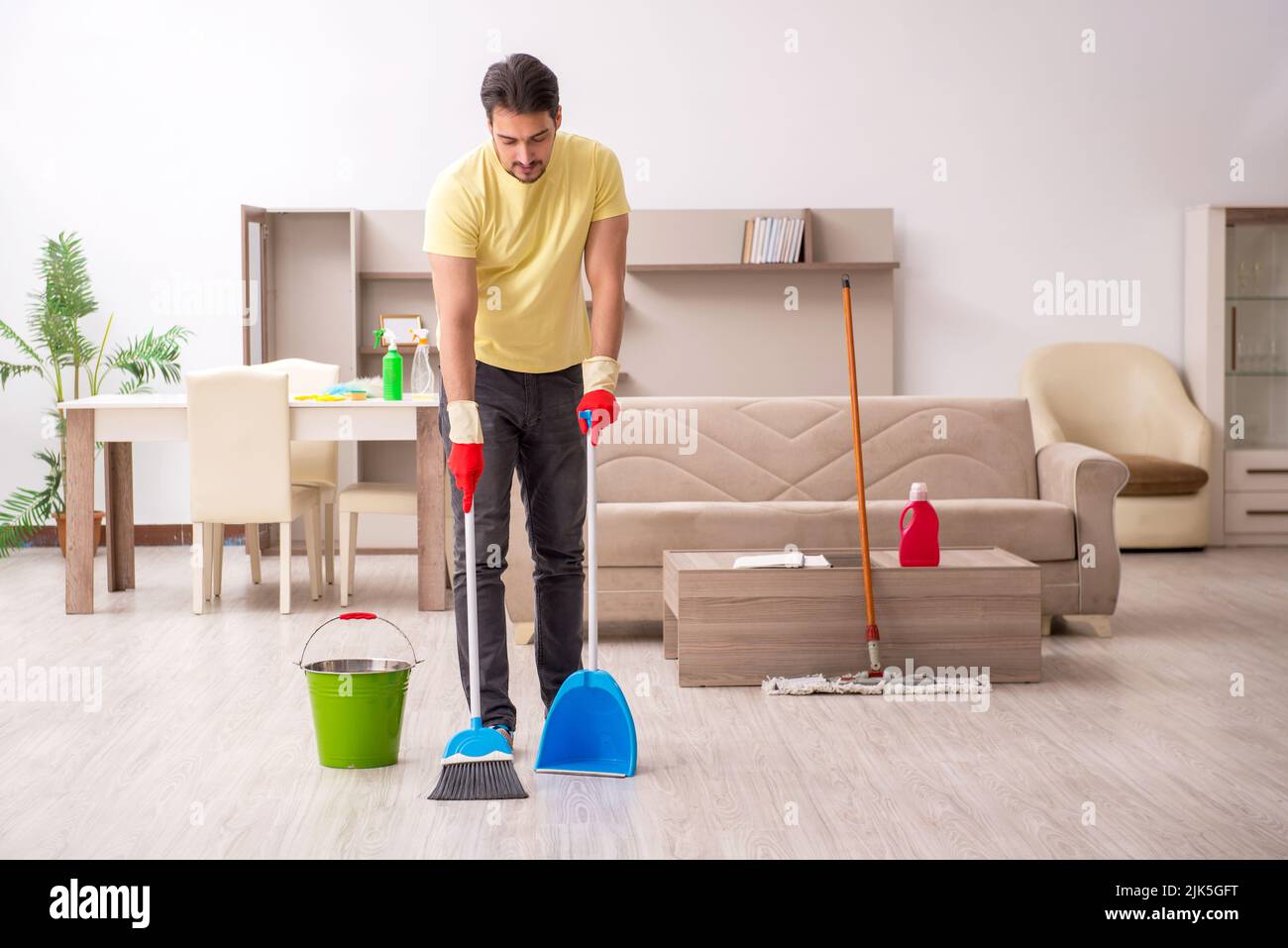 Young male cleaner cleaning the house Stock Photo - Alamy