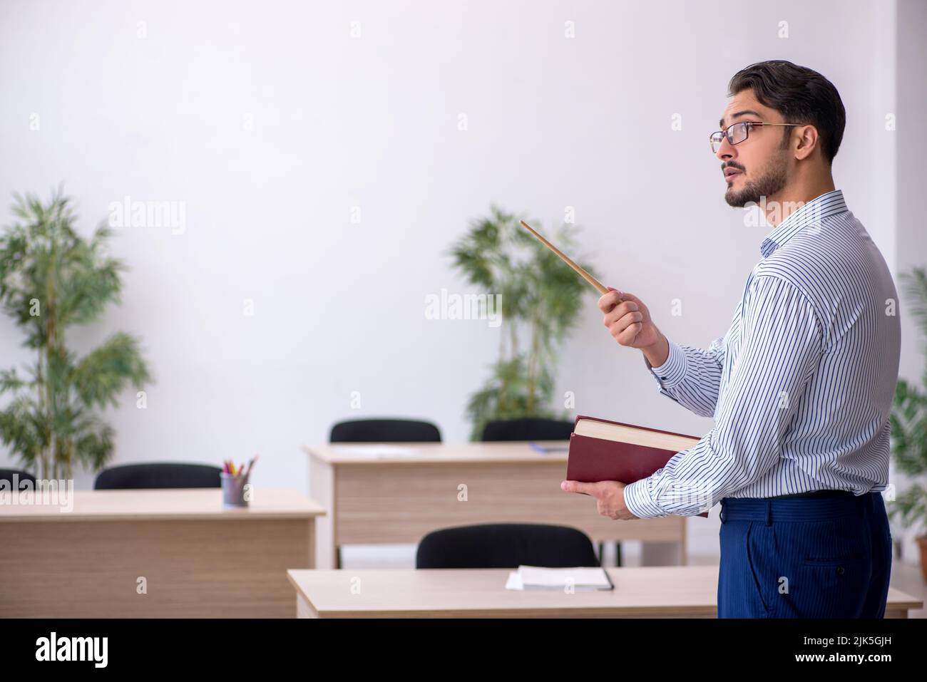 Young teacher in the classroom Stock Photo - Alamy