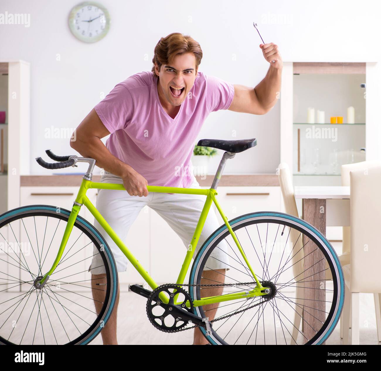 Man repairing his broken bicycle Stock Photo - Alamy