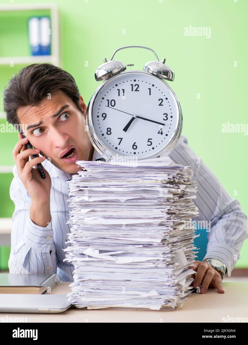The businessman having problems with paperwork and workload Stock Photo ...
