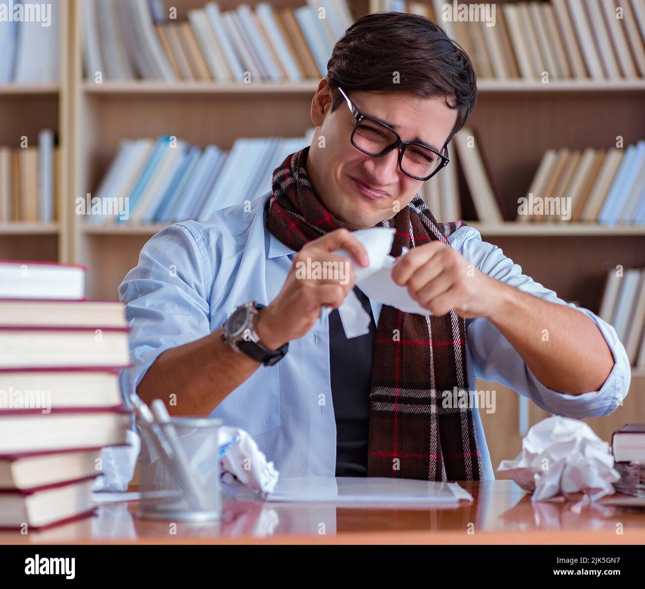 The young book writer writing in library Stock Photo - Alamy