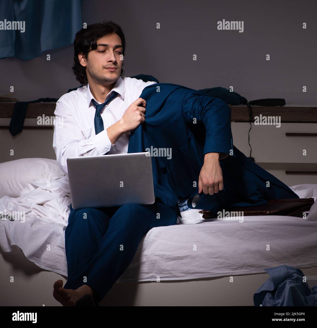 The young employee working at home after night shift Stock Photo - Alamy