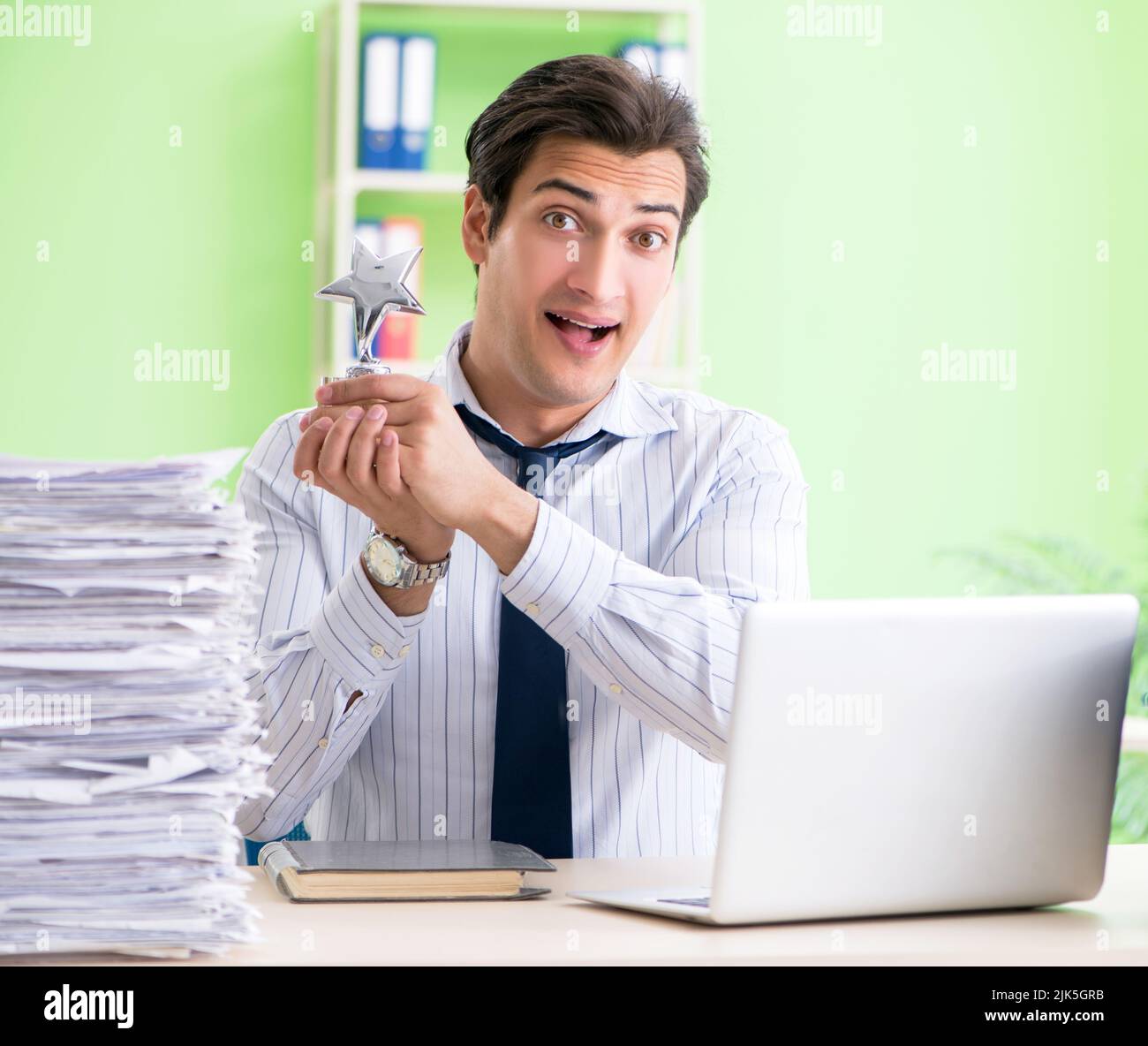 The businessman having problems with paperwork and workload Stock Photo ...