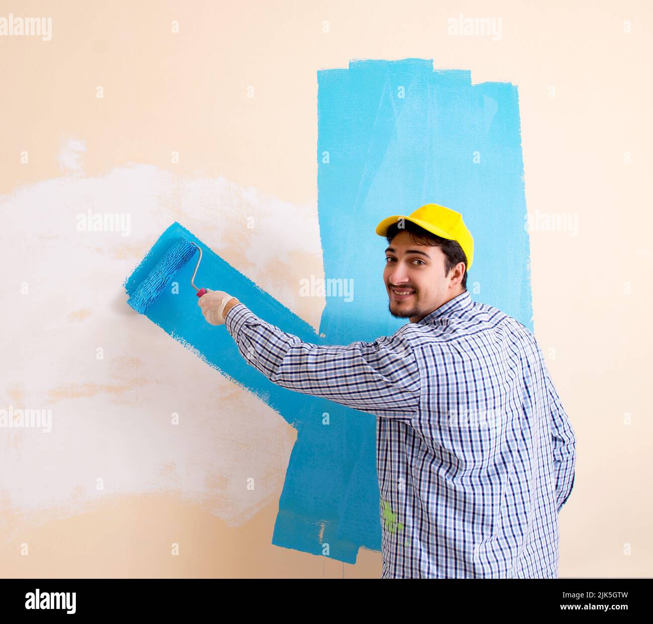 The painter man painting the wall at home Stock Photo - Alamy