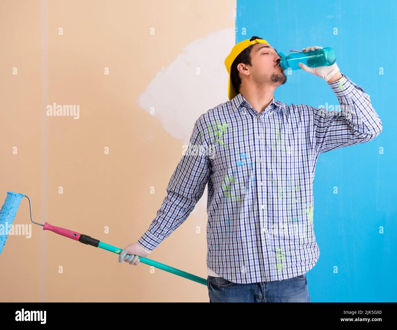 The painter man painting the wall at home Stock Photo - Alamy