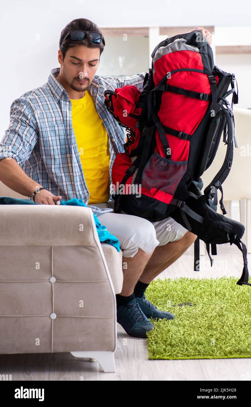 The backpacker packing for his trip Stock Photo - Alamy