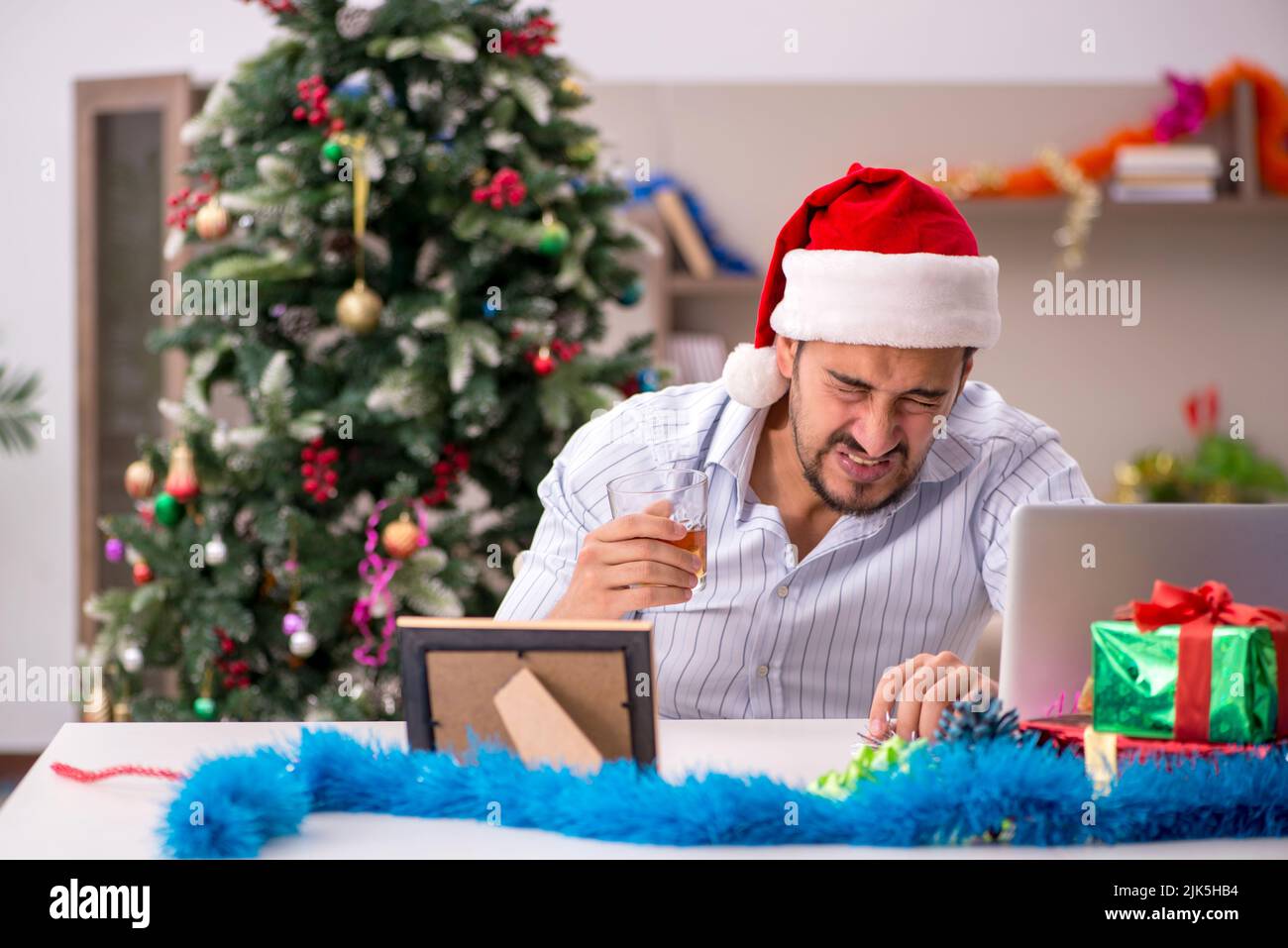 Young man celebrating New year at home alone Stock Photo - Alamy