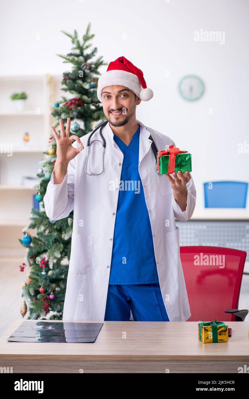 Doctor santa holding merry christmas hi-res stock photography and ...