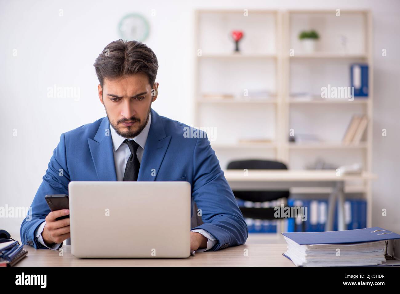 Deaf businessman employee using hearing aid in the office Stock Photo ...