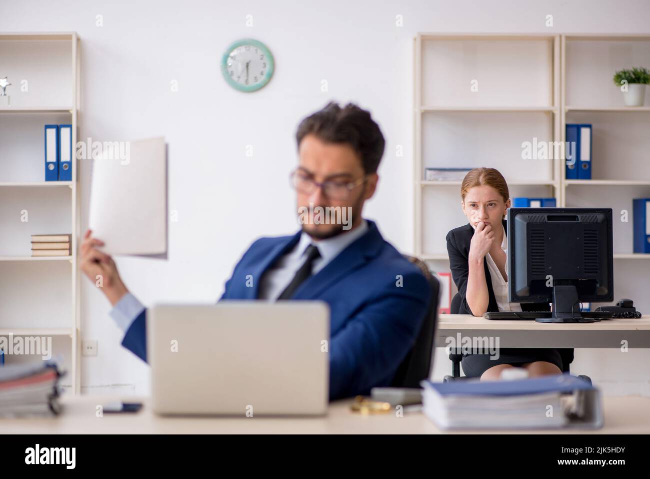 Two colleagues sitting in the office Stock Photo - Alamy
