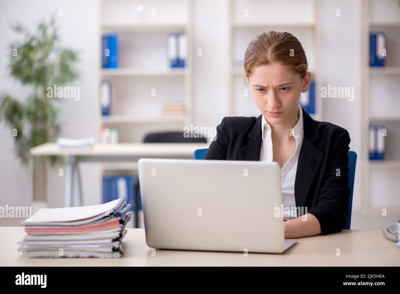Female employee sitting at workplace Stock Photo - Alamy
