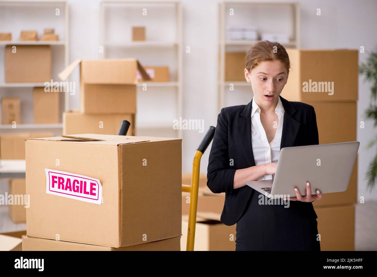 Female professional mover doing home relocation Stock Photo - Alamy