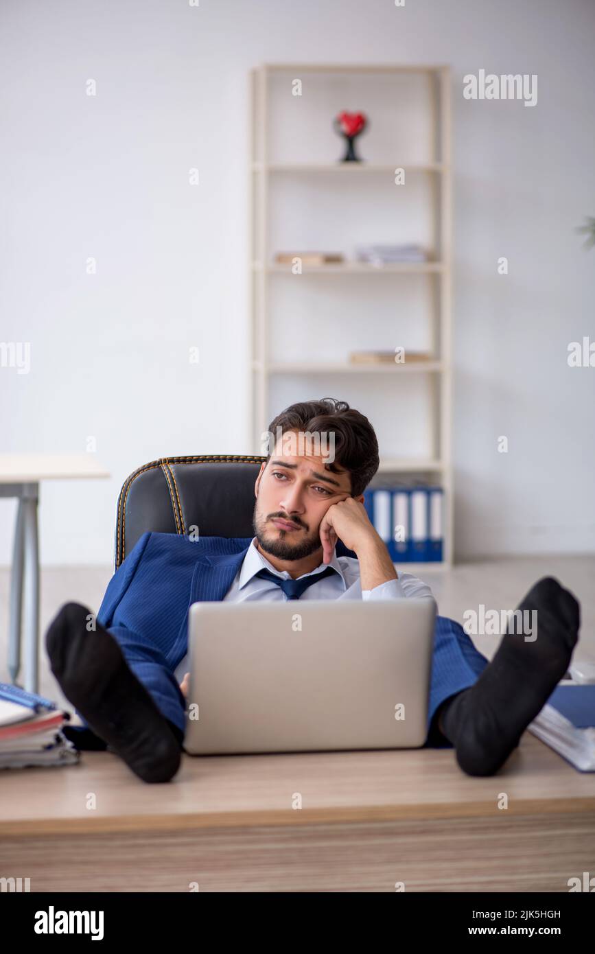 Young businessman employee extremely tired at workplace Stock Photo - Alamy