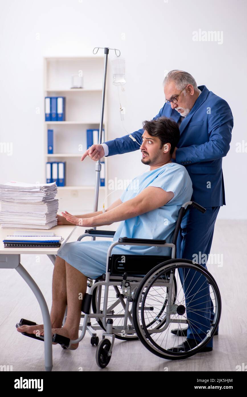 Young employee in wheel-chair feeling bad at workplace Stock Photo - Alamy