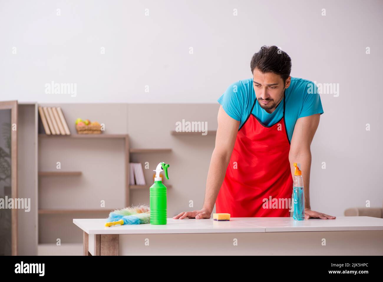 Young contractor cleaning the house Stock Photo - Alamy