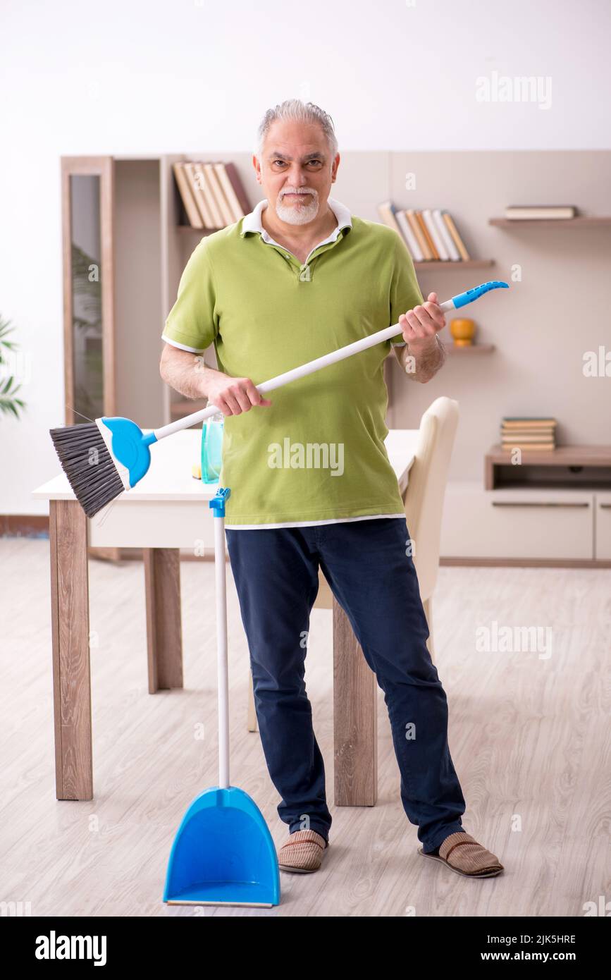 Aged man cleaning the house Stock Photo - Alamy