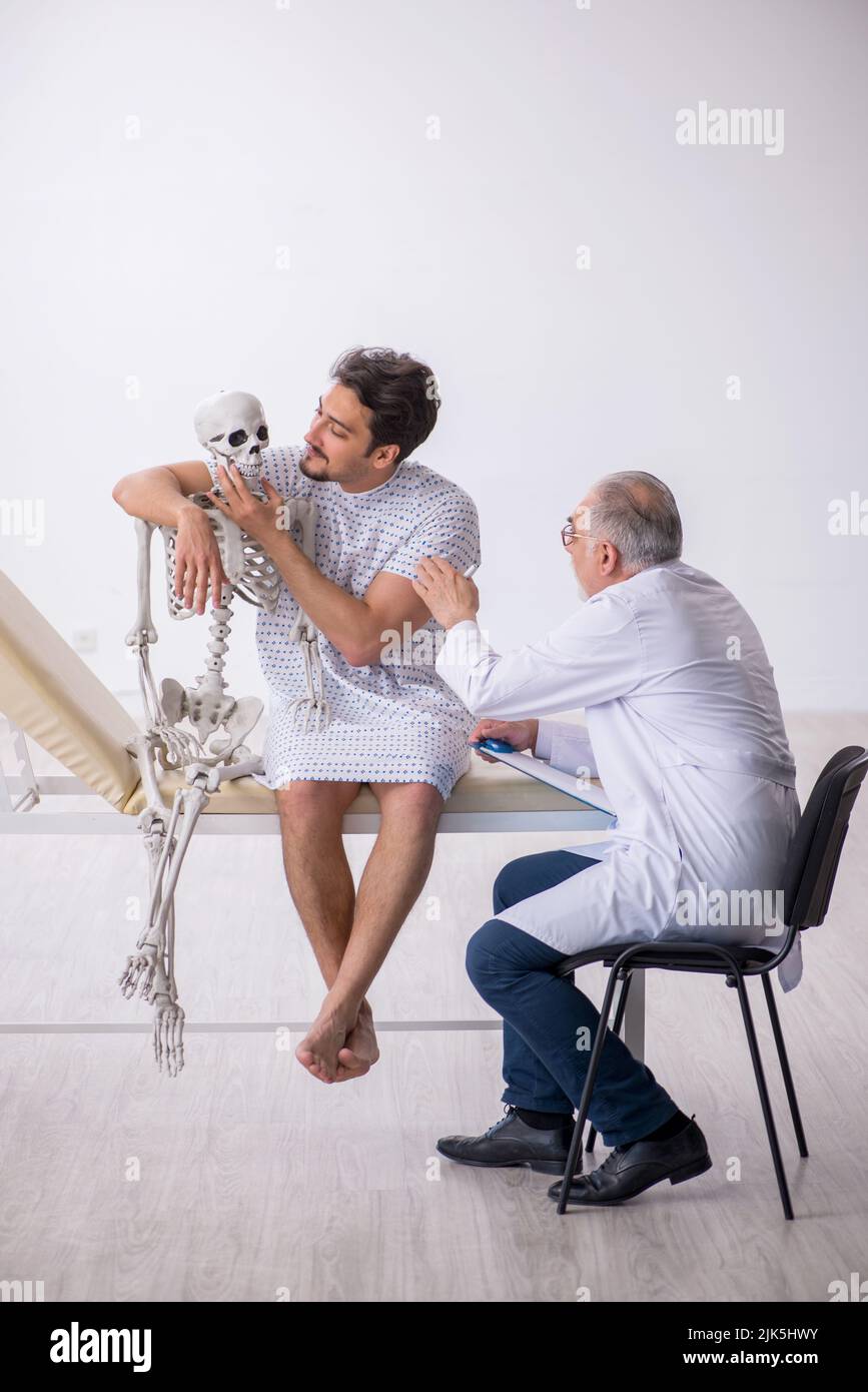 Old doctor psychiatrist examining young male patient Stock Photo - Alamy