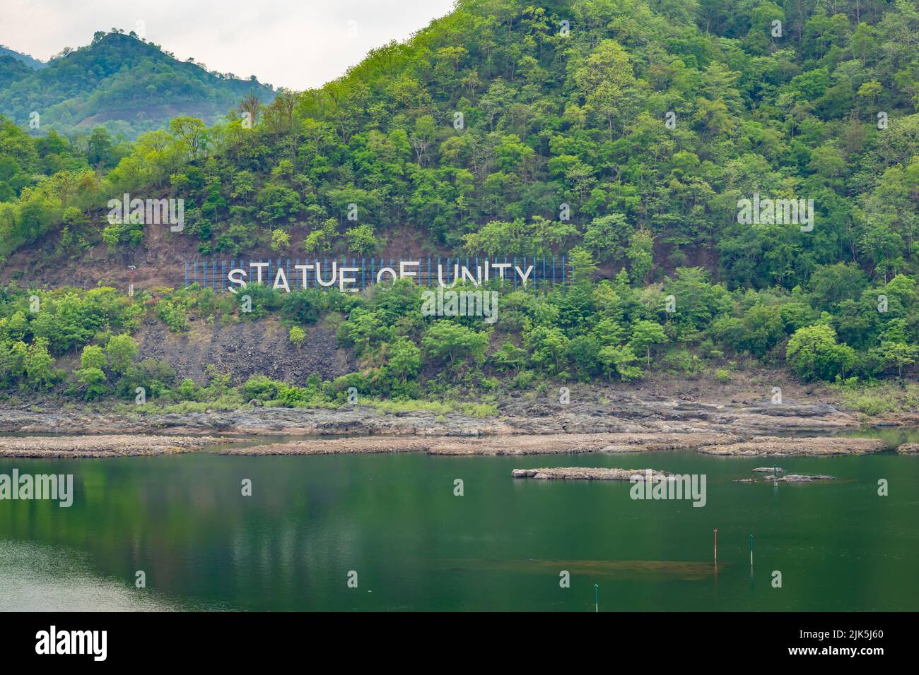 statue of unity board written at green mountain with river at morning ...