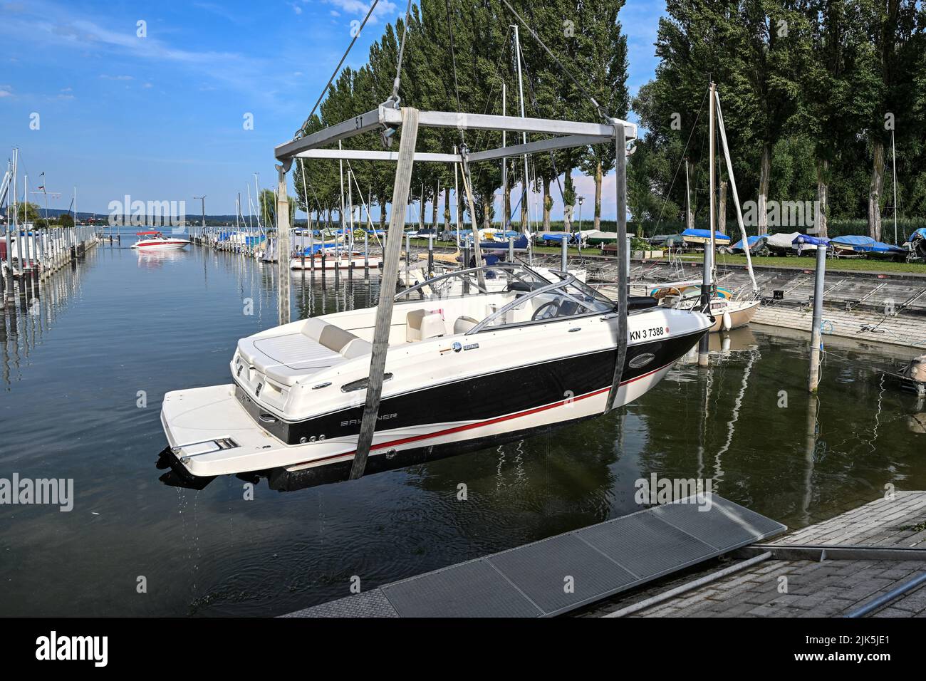 Moos Am Bodensee, Germany. 28th July, 2022. A crane hoists a motorboat ...