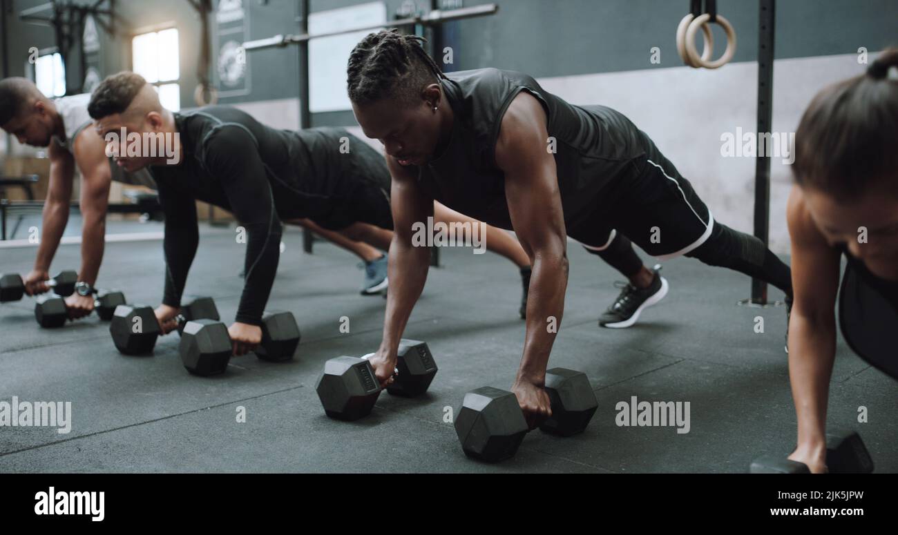 Building excellent upper body strength. a group of sporty young people ...