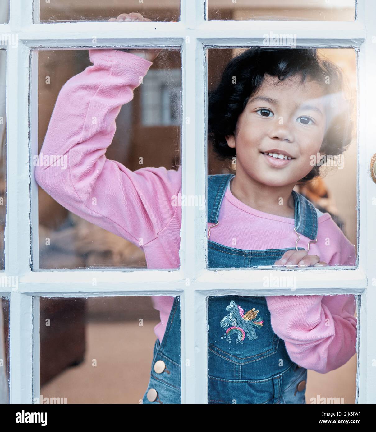 Can I go play already. an adorable little girl looking through the ...