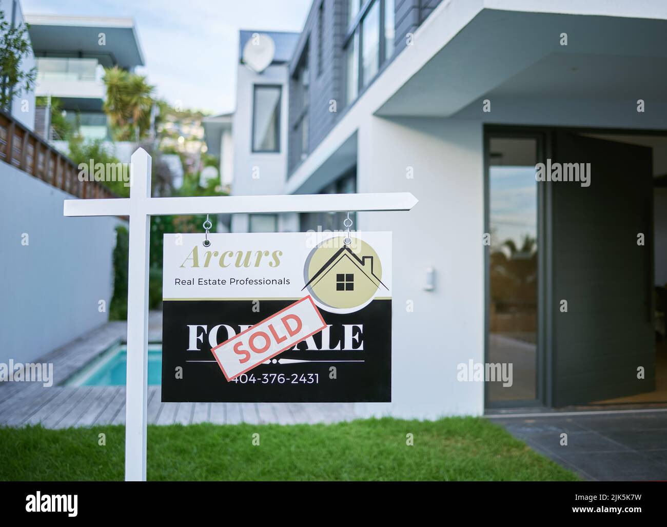 This house just became a home. a sold sign in a yard of a newly bought ...