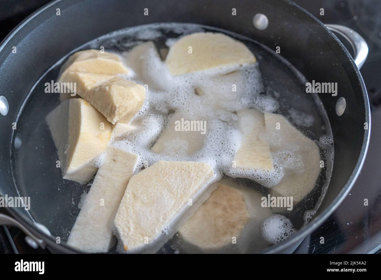 Slices of Yam boiling in a pot for lunch Stock Photo - Alamy