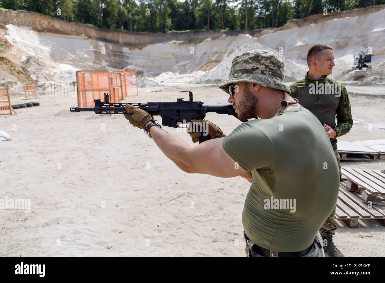 Ukrainian civilian takes part in a shooting training to learn military ...