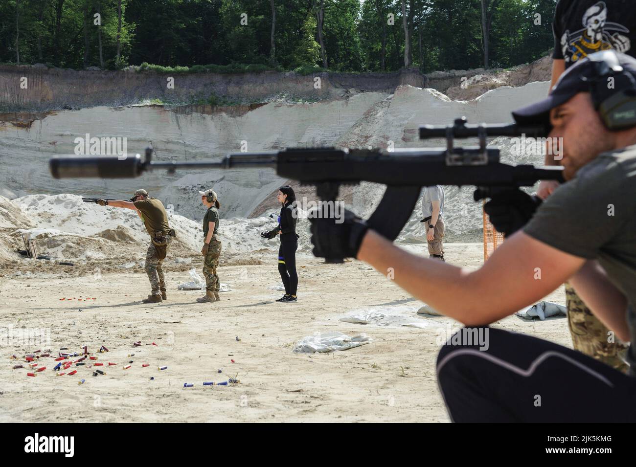 Ukrainian civilians take part in a shooting training to learn military ...