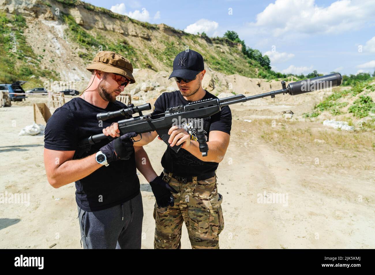Ukrainian civilians take part in a shooting training to learn military ...