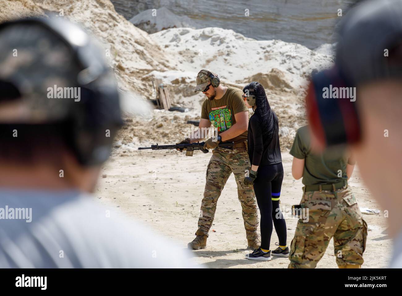 Ukrainian civilians take part in a shooting training to learn military ...