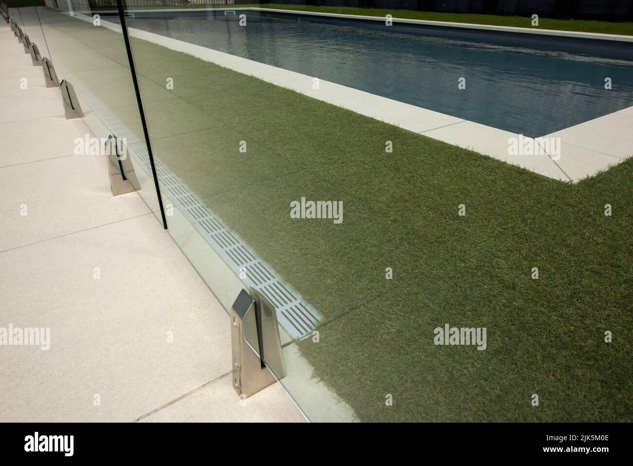 Swimming pool glass safety fence detail Stock Photo - Alamy