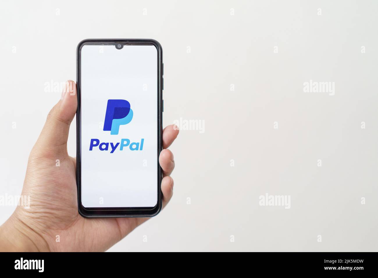 A hand holds smartphone shows PayPal logo Stock Photo - Alamy
