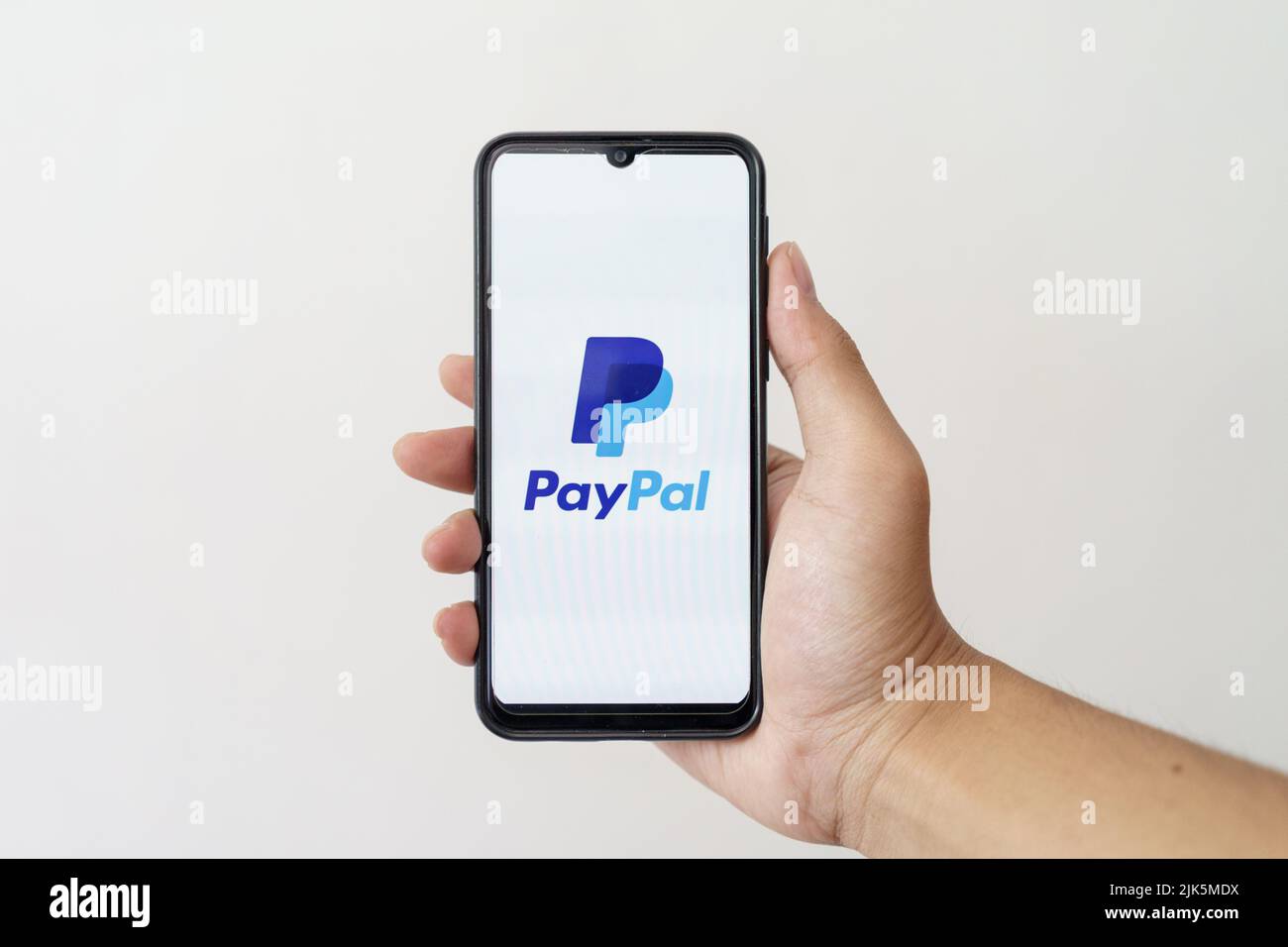 A hand holds smartphone shows PayPal logo Stock Photo - Alamy
