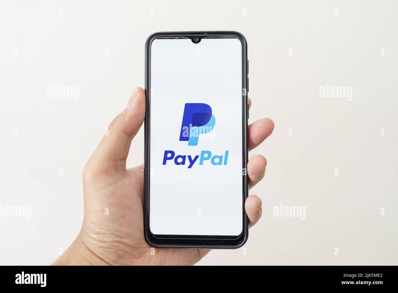 A hand holds smartphone shows PayPal logo Stock Photo - Alamy