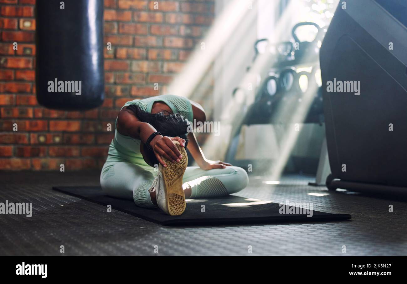 What you want youve got to work for. a young woman stretching before ...