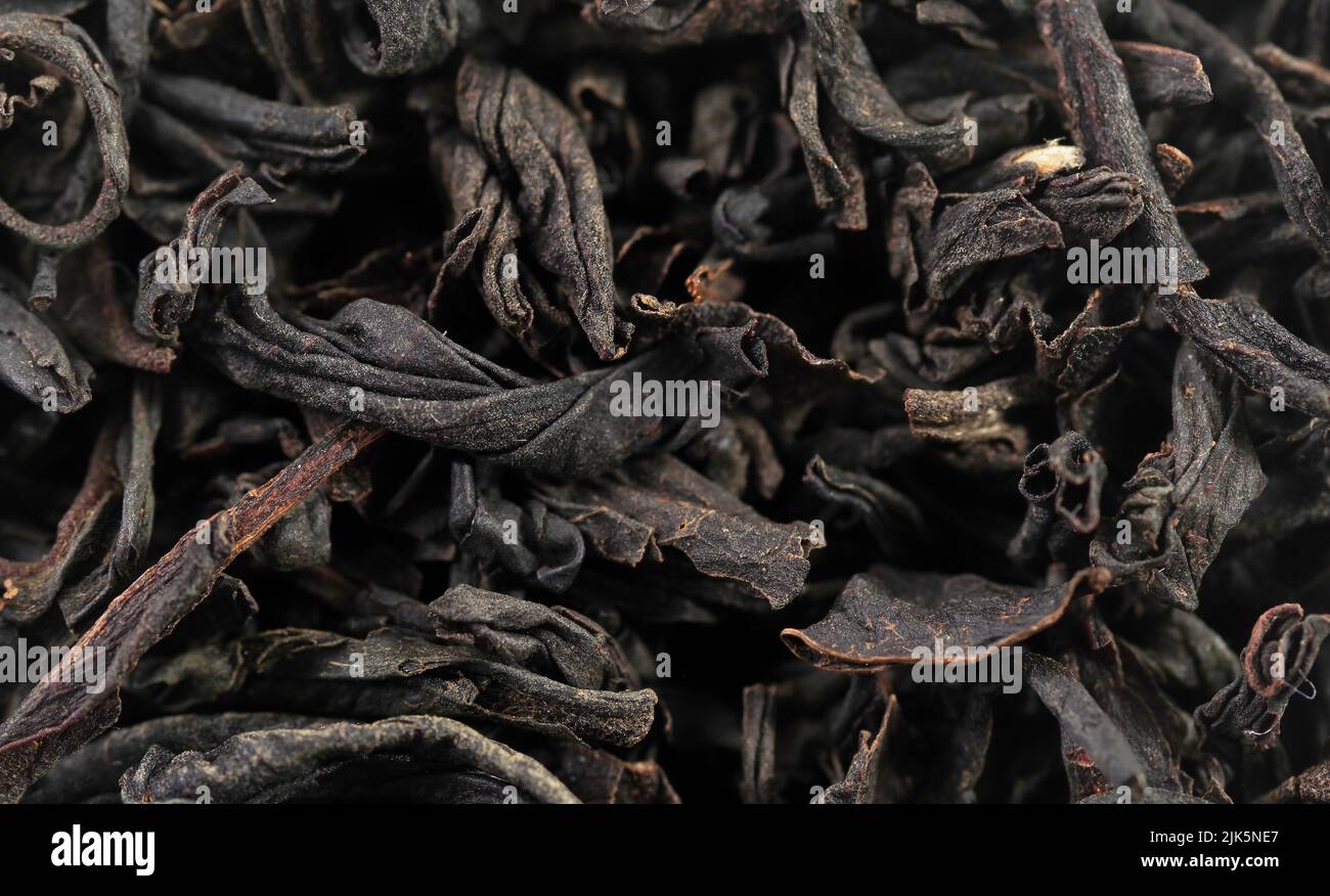 Premium black loose leaf tea as a background. Texture of dry black tea ...