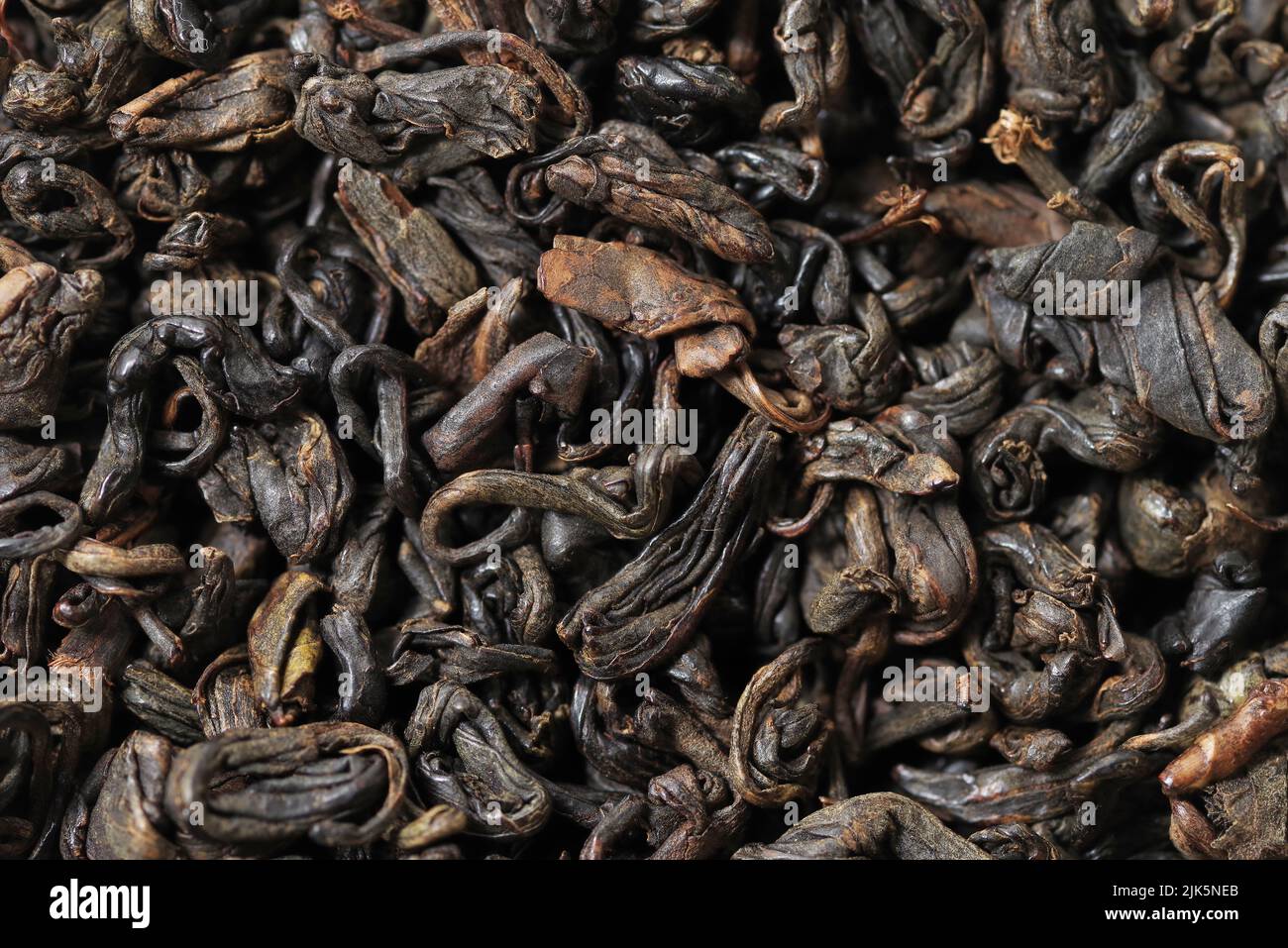 Premium black loose leaf tea as a background. Texture of dry black tea ...