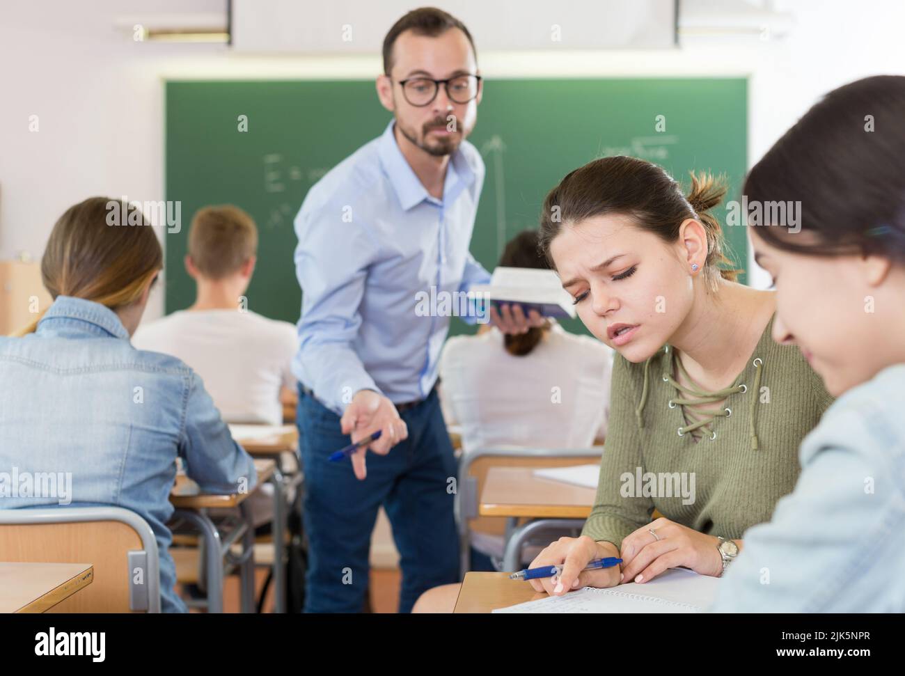 Young girls are talking in time lecture and teacher is disturbance it ...