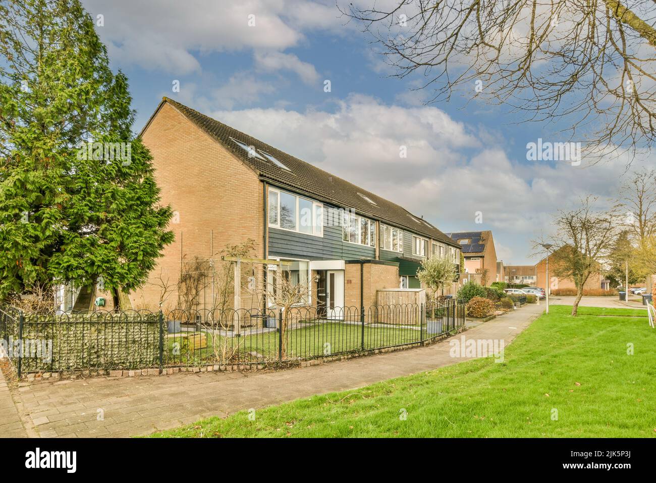 The front view of a brick building with signs, pavement and wooden ...