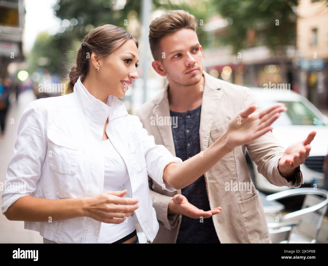 Traveller asking woman direction Stock Photo - Alamy